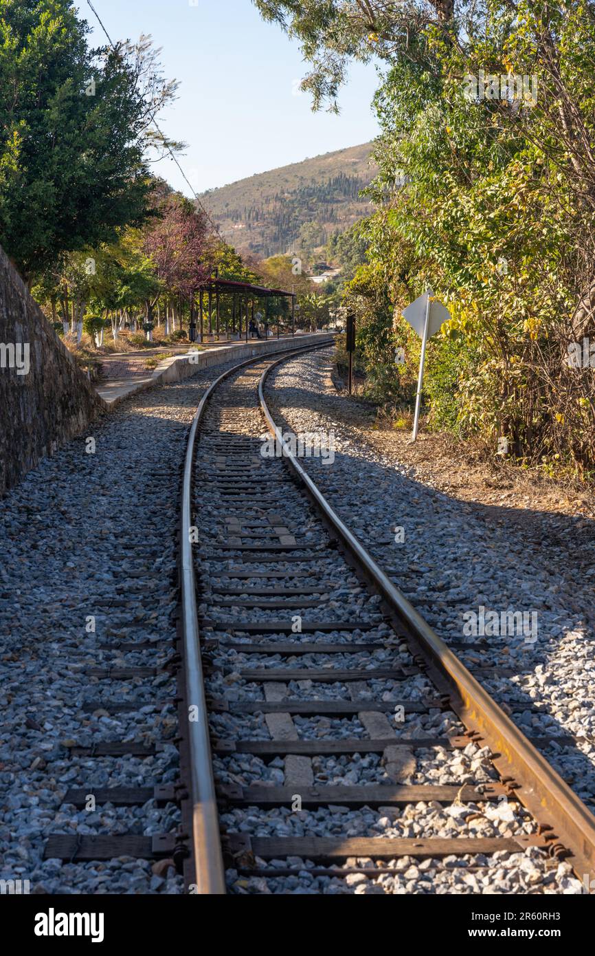 A winding railway track curves through the landscape, leading away into ...
