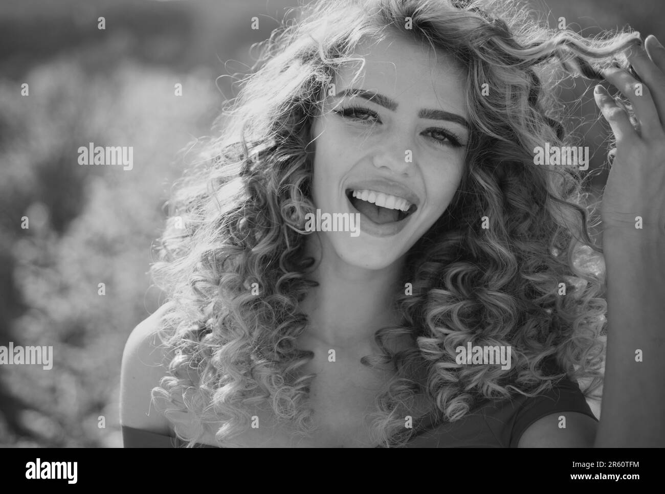 Shampoo concept. Curly hair. Woman holding curly hair on Spring ...