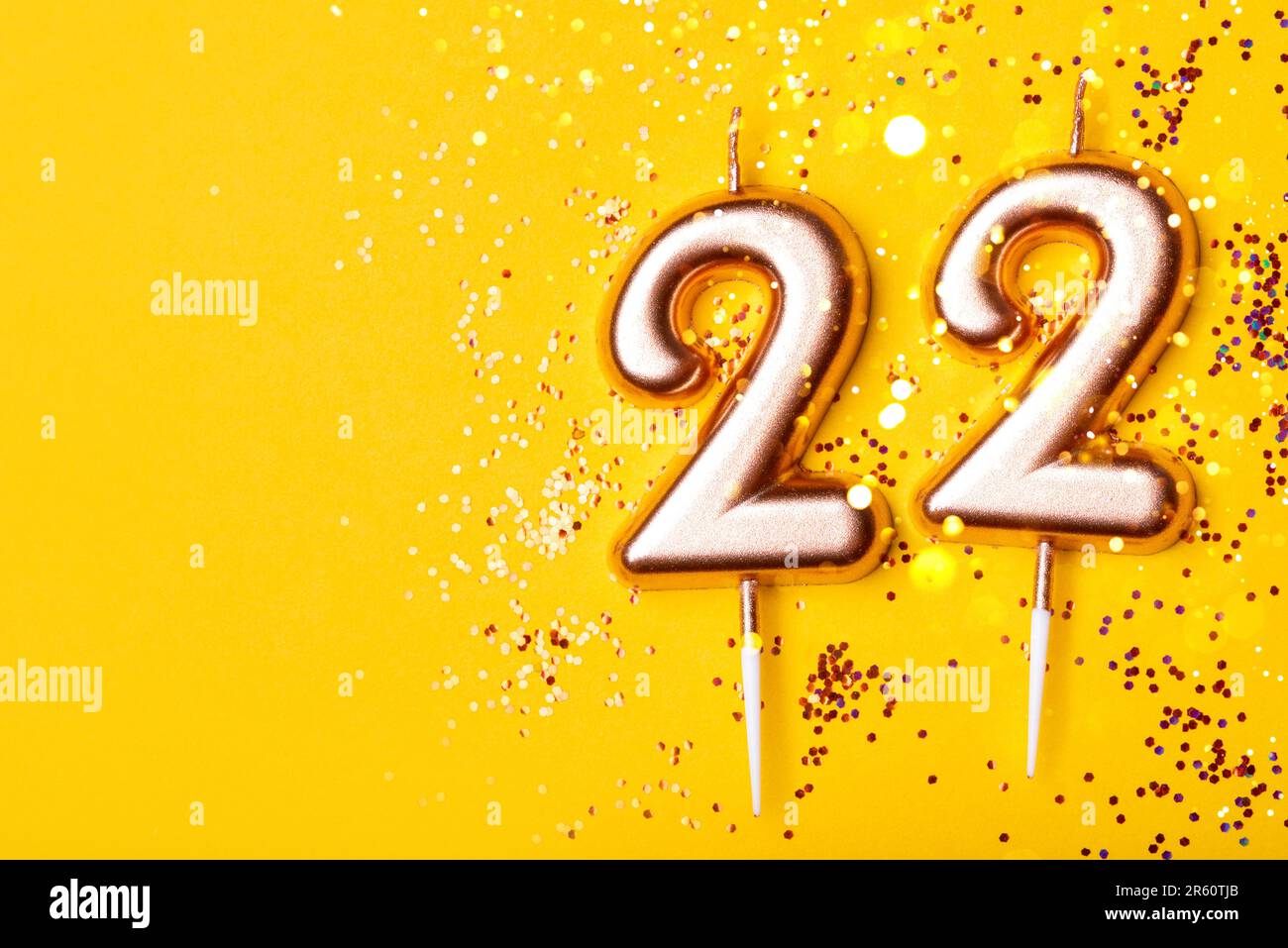 22 years celebration. Greeting banner. Gold candles in the form of ...