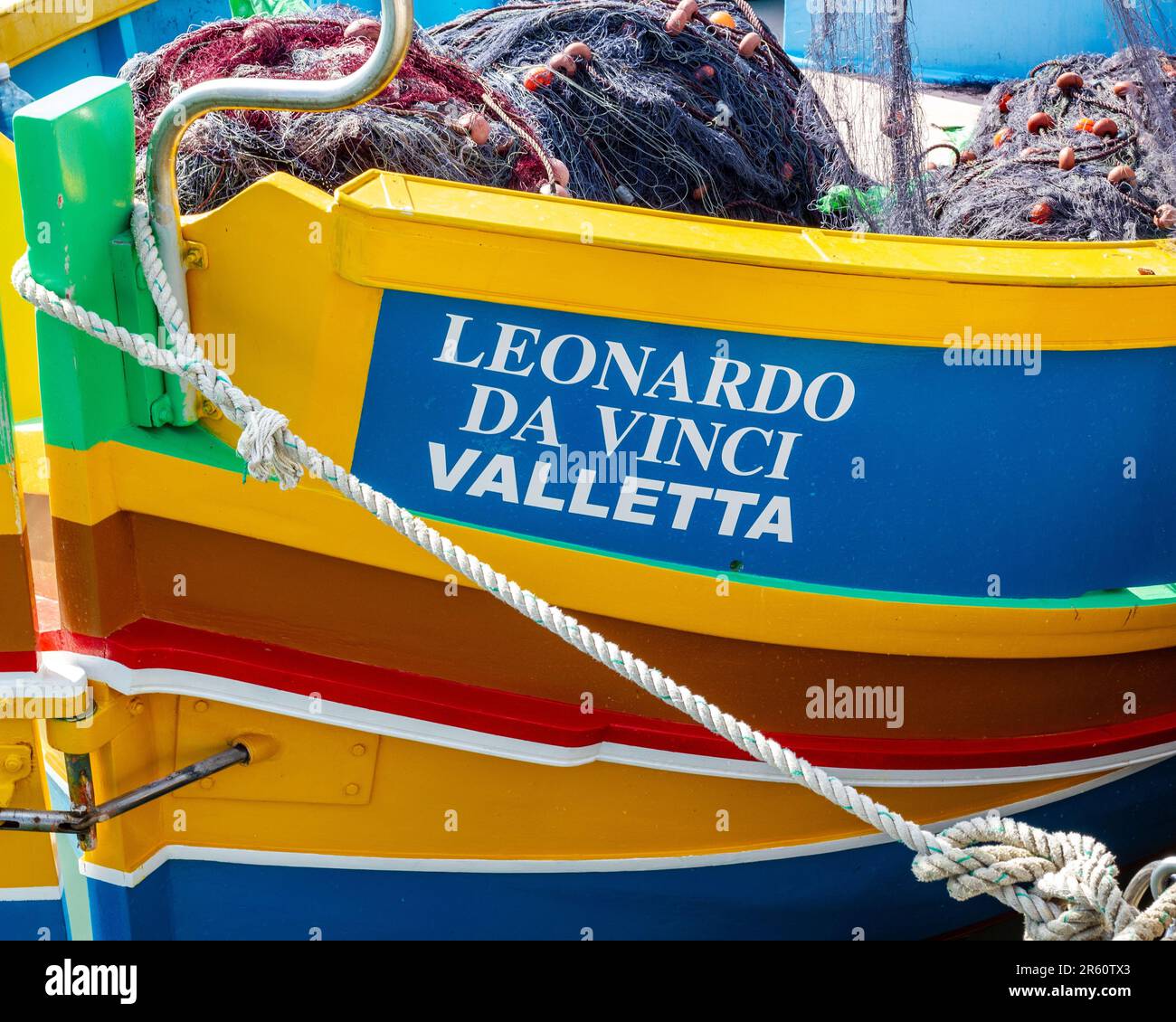 A brightly colored boat with the name Leonardo da Vinci on its hull ...
