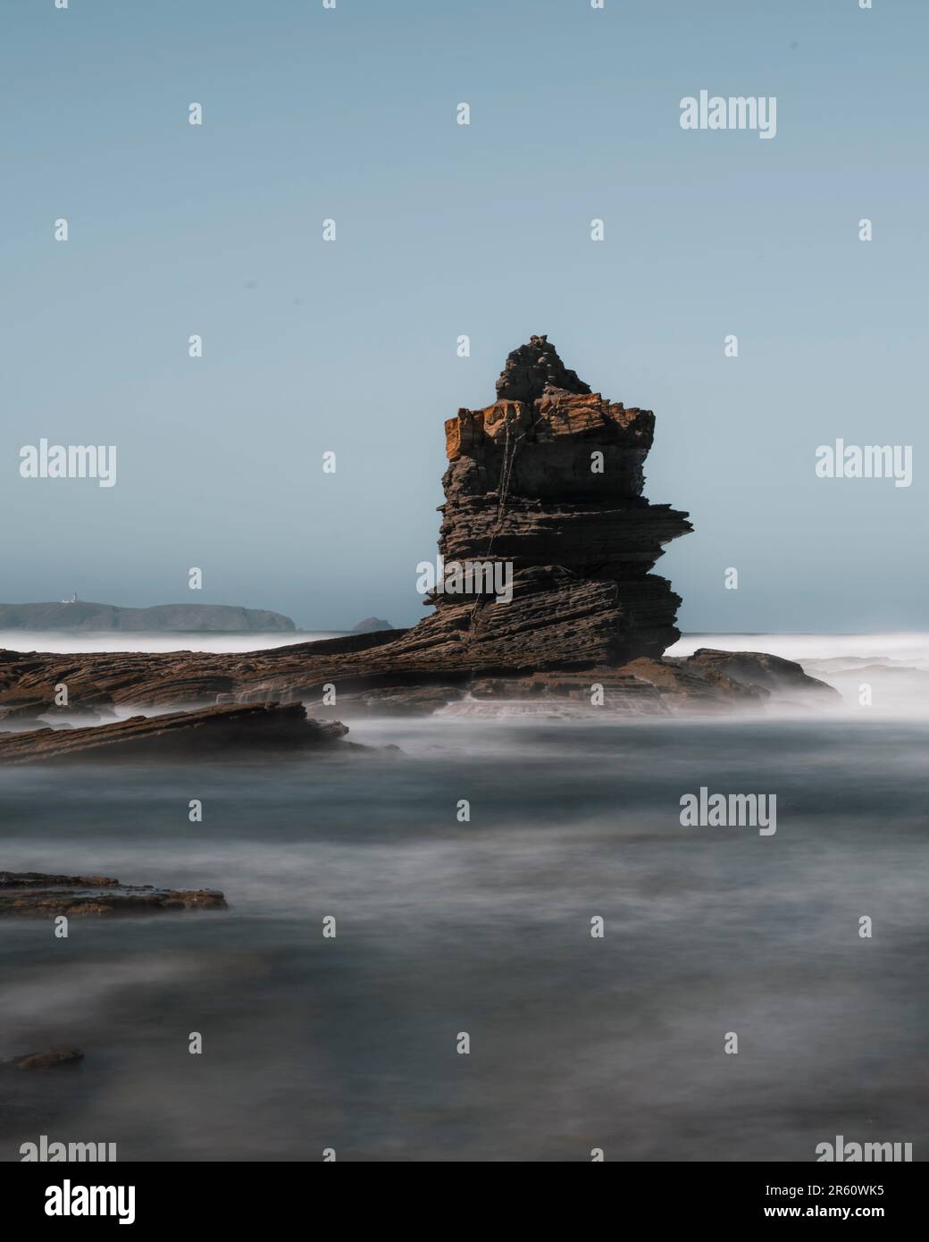 A scenic image featuring an impressive rock formation rising from the ...