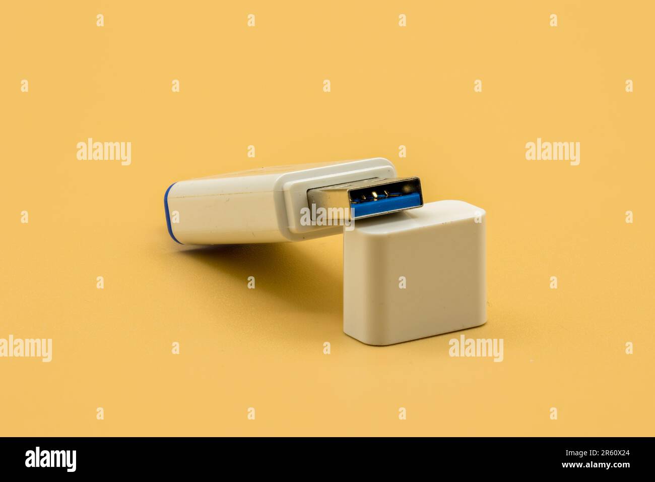 A white and blue USB flash drive placed on its own cap Stock Photo - Alamy