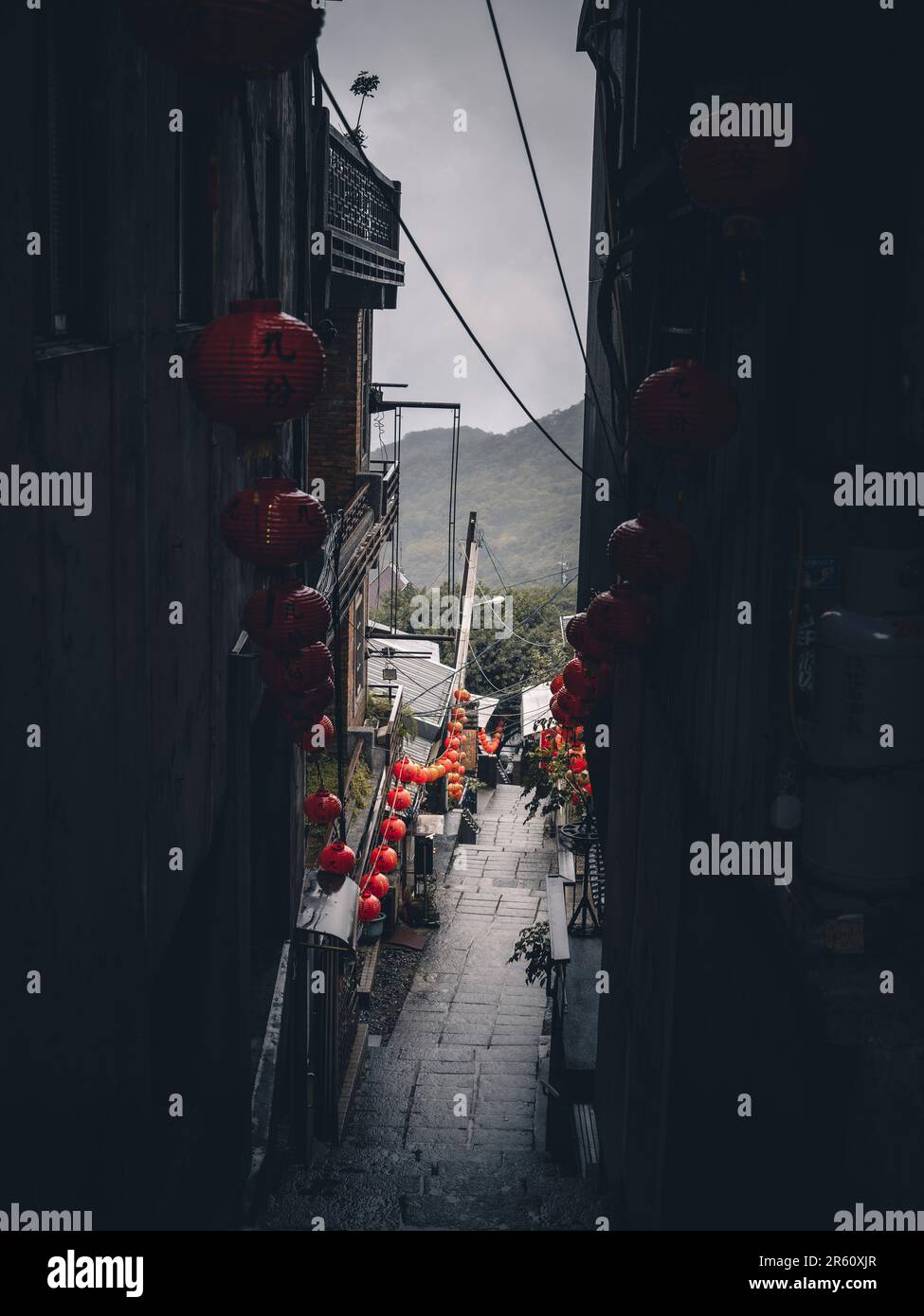 A picturesque street in a cityscape, illuminated by red paper lanterns ...