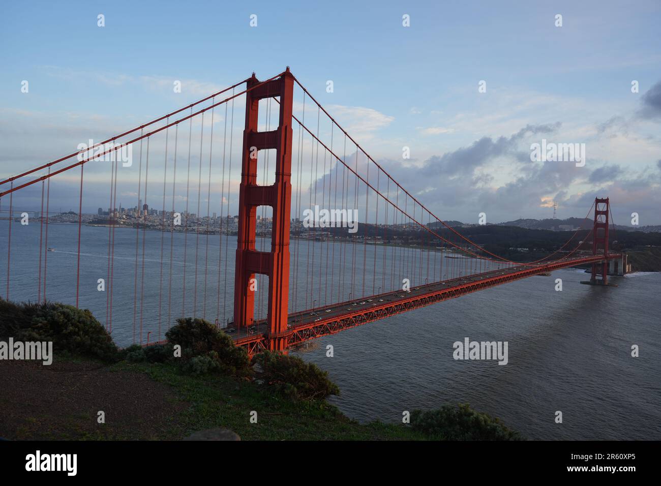 An aerial view of an arch bridge spanning a wide body of water and ...