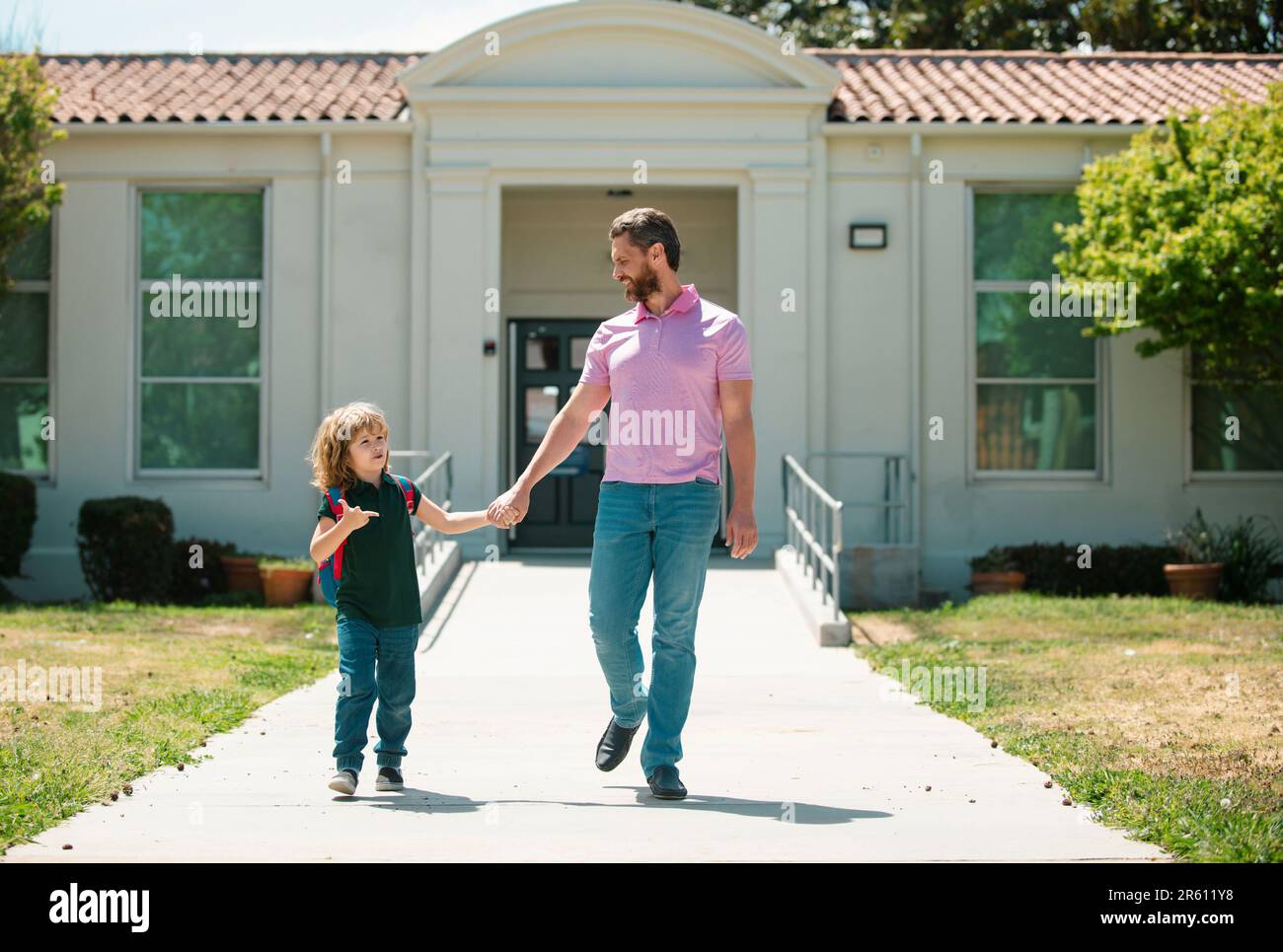 Father and son run with father after come back from school. School ...