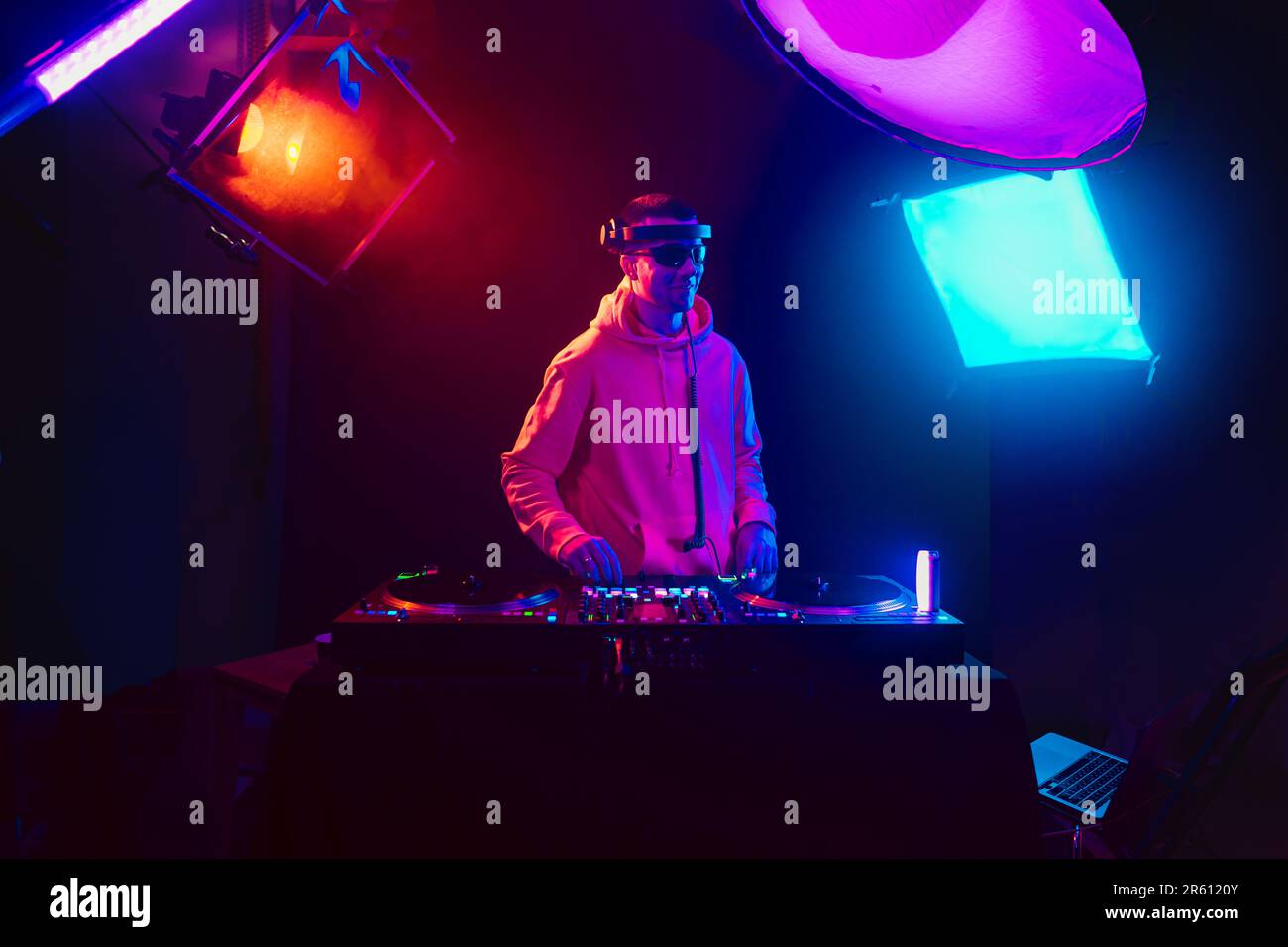 Male DJ playing music in the night club Stock Photo - Alamy