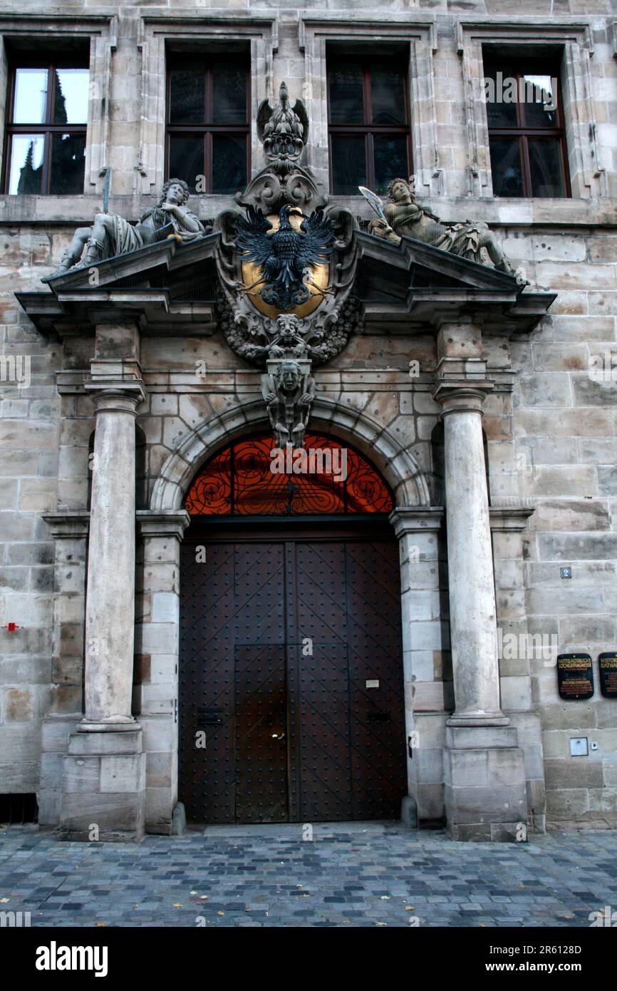 A high-rise, brown-colored building with a doorway entrance leading to ...