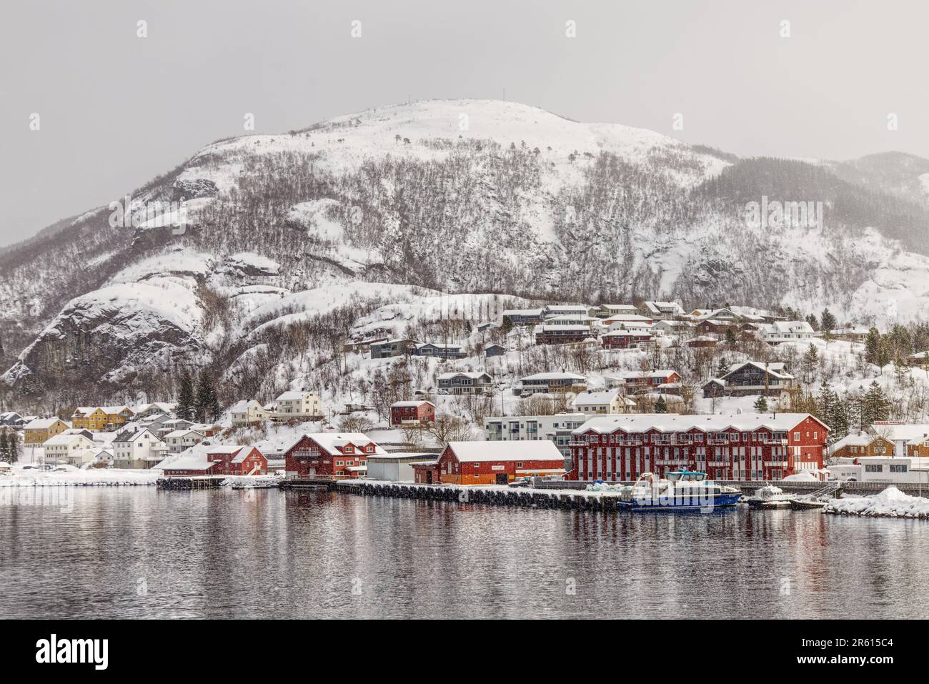 Tromso, Troms og Finnmark, Norway - mountains, coastline and harbour after snow viewed from ship ...