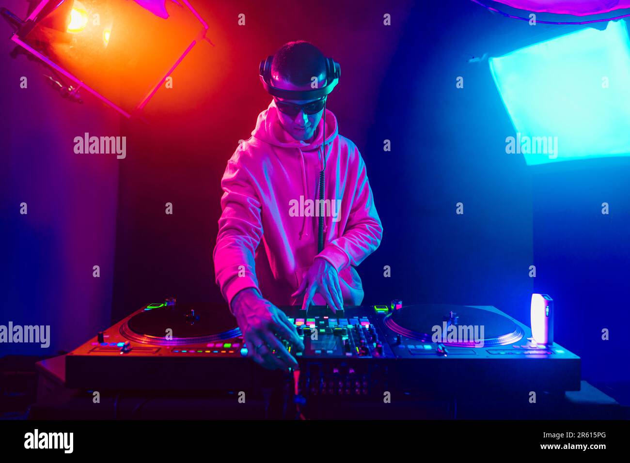 Male DJ playing music in the night club Stock Photo - Alamy