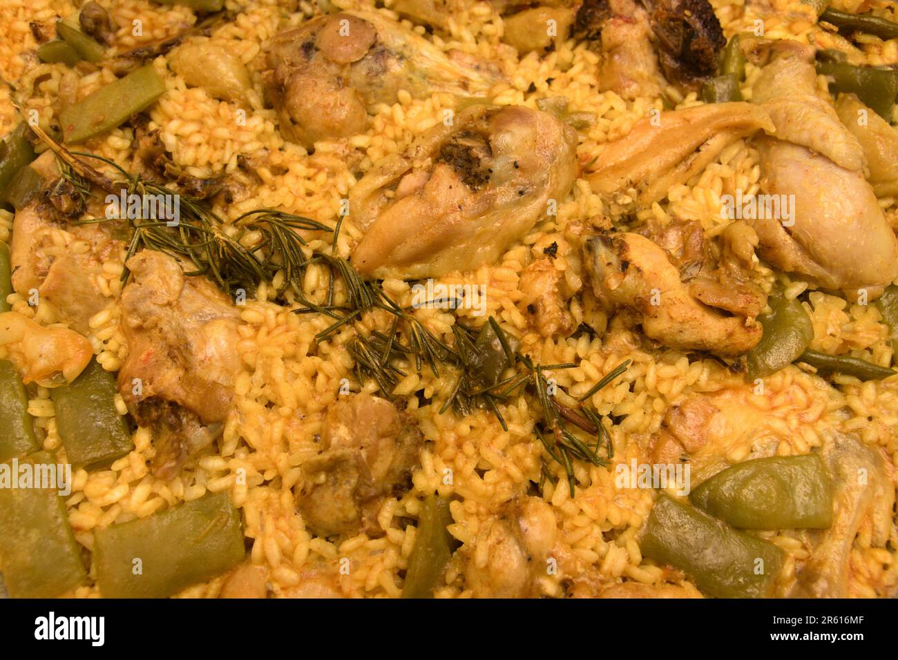 Detail of the surface of a freshly cooked Valencian paella with rice ...