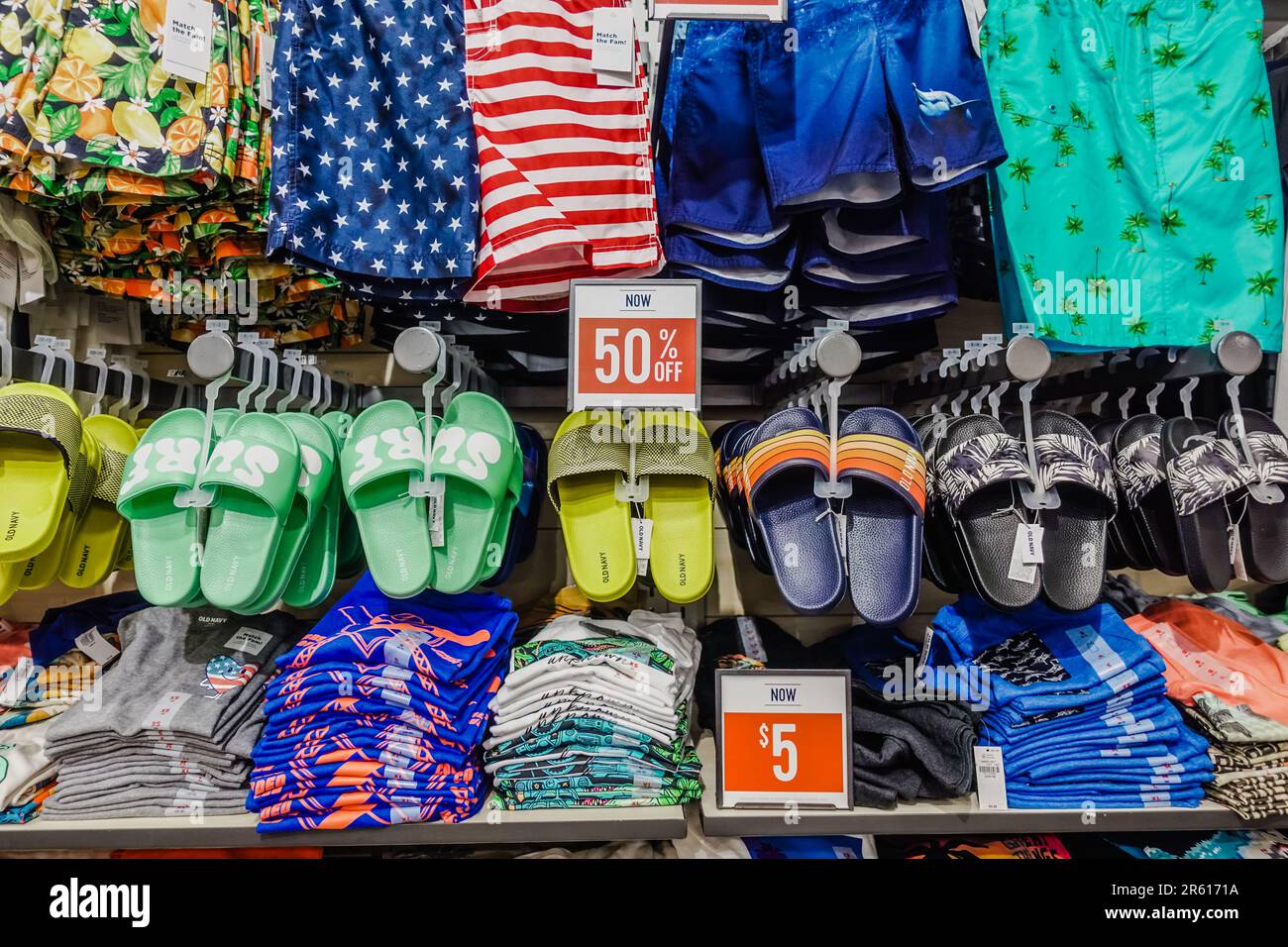 Summer flip flops and shorts displayed inside a store Stock Photo - Alamy
