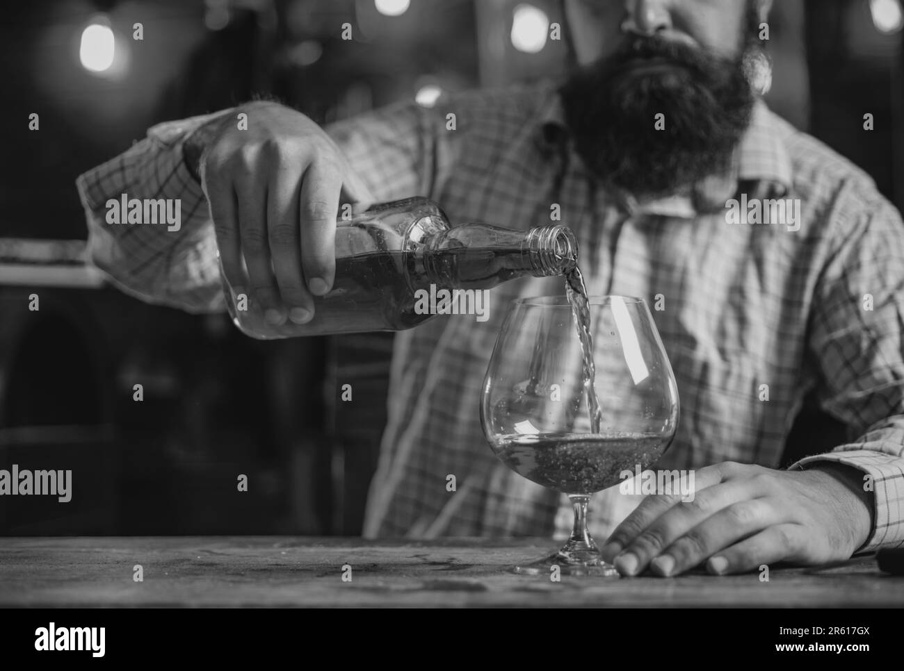Bartender pours alcohol shaker Black and White Stock Photos & Images ...