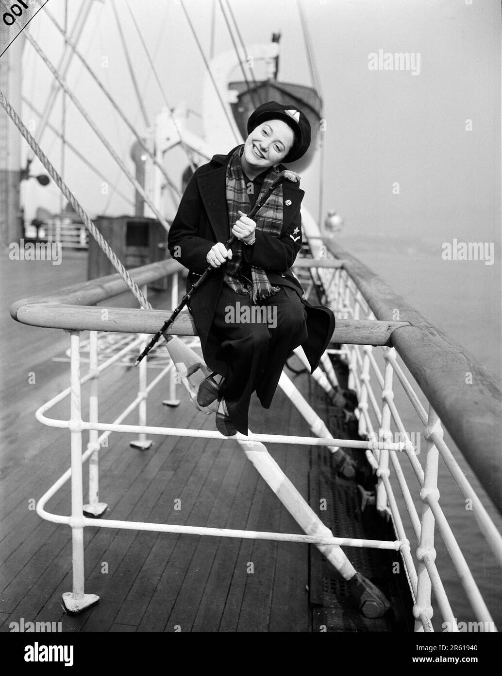 Helen Morgan, nightclub entertainer, is shown seated on a ship railing ...