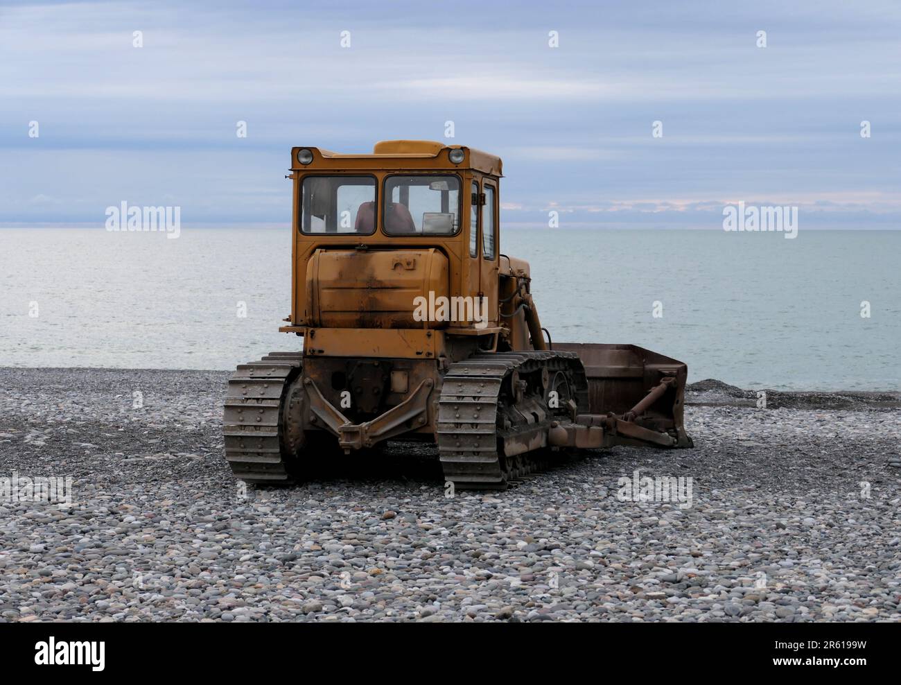 yellow bulldozer on an empty beach Stock Photo - Alamy