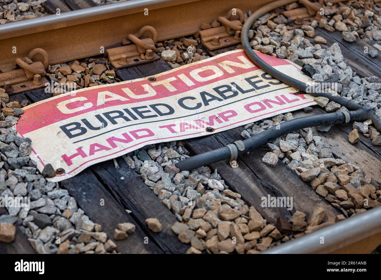A caution sign on train tracks Stock Photo - Alamy