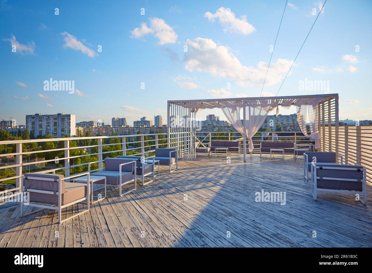 Rooftop cafe, open terrace with wooden tables Stock Photo - Alamy