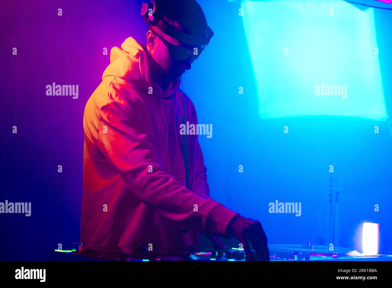 Male DJ playing music in the night club Stock Photo - Alamy