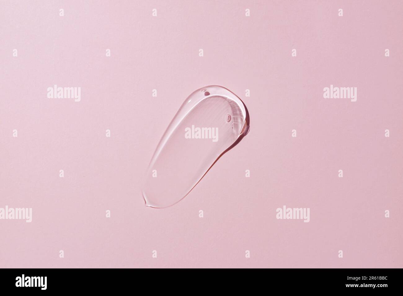 Glycerin gel texture. Transparent serum drop on pink background. Liquid ...
