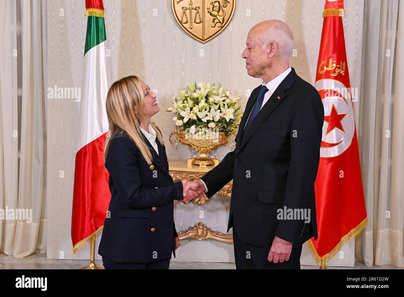 Tunisian President Kais Saied, right, shakes hands with Italian Prime ...