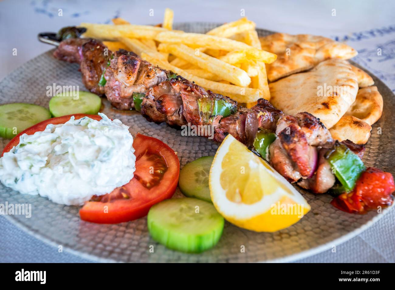 Greek pork Souvlaki with tzatziki sauce and fresh vegetables, grilled ...