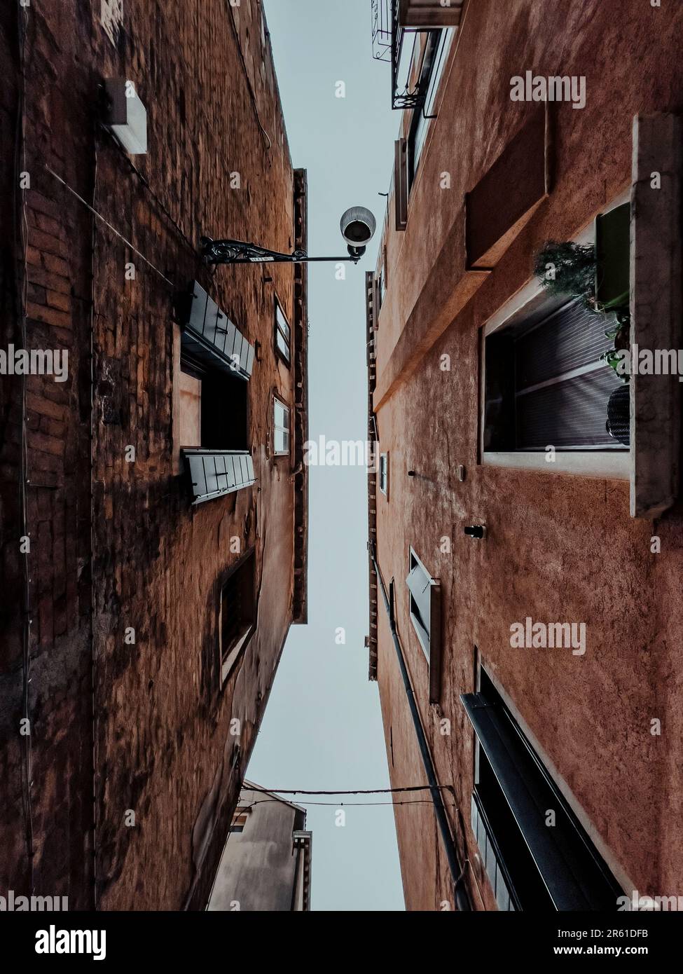 A low-angle shot of two old stone buildings in front of each other ...