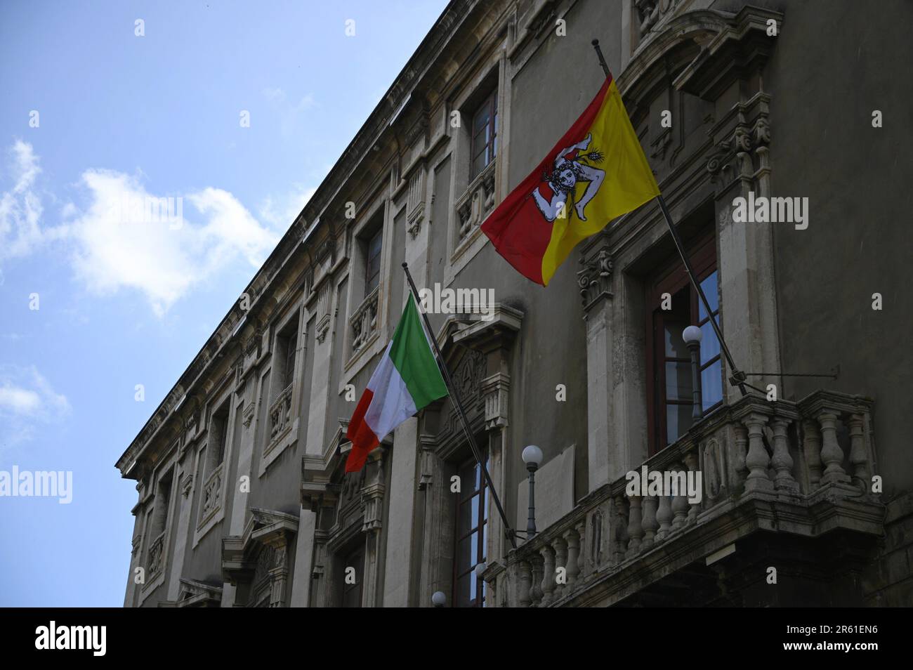 Scenic exterior view of a historic public building with the flags of ...
