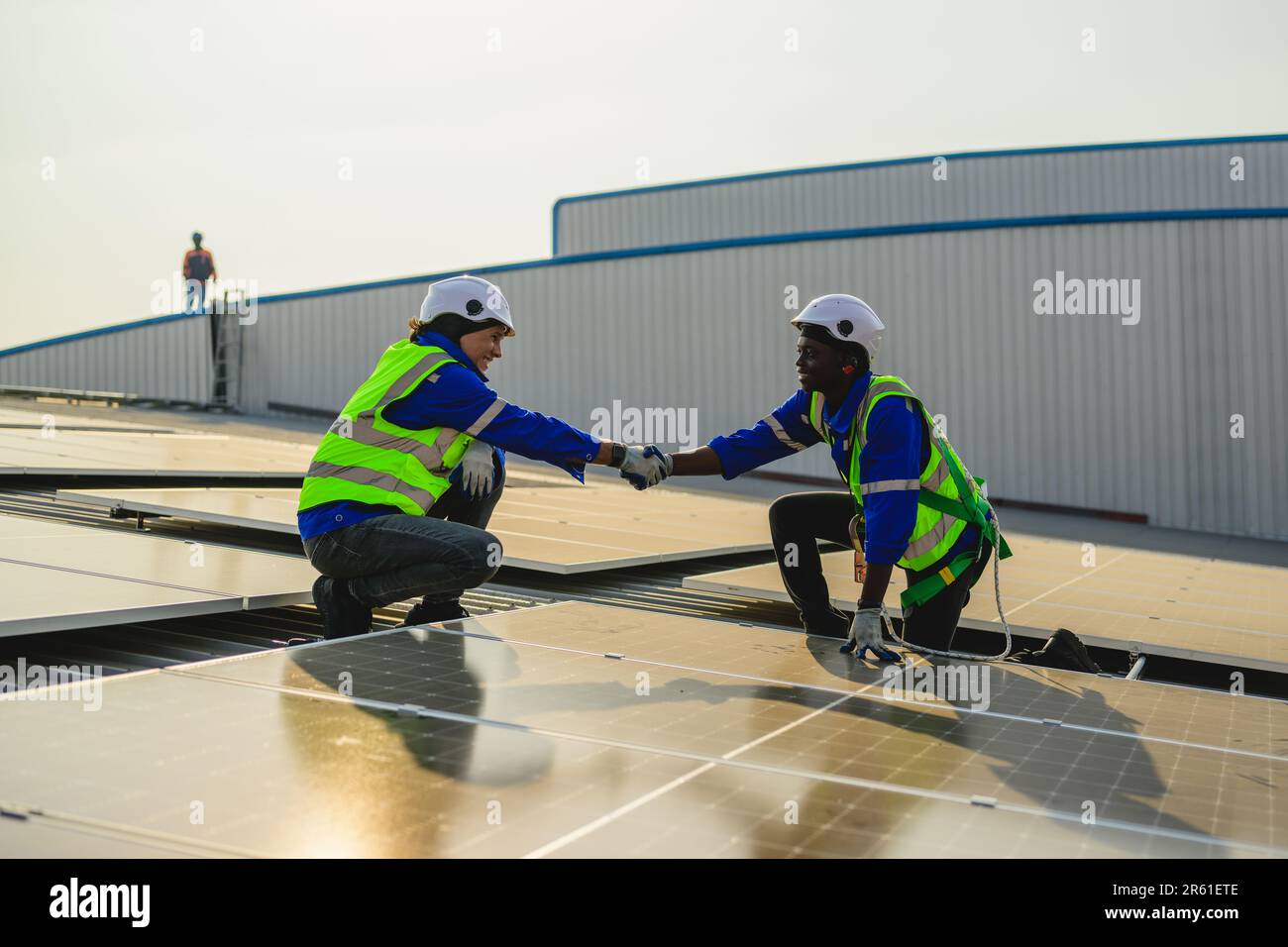 Maintenance technicians installing solar panels at solar cell farm ...