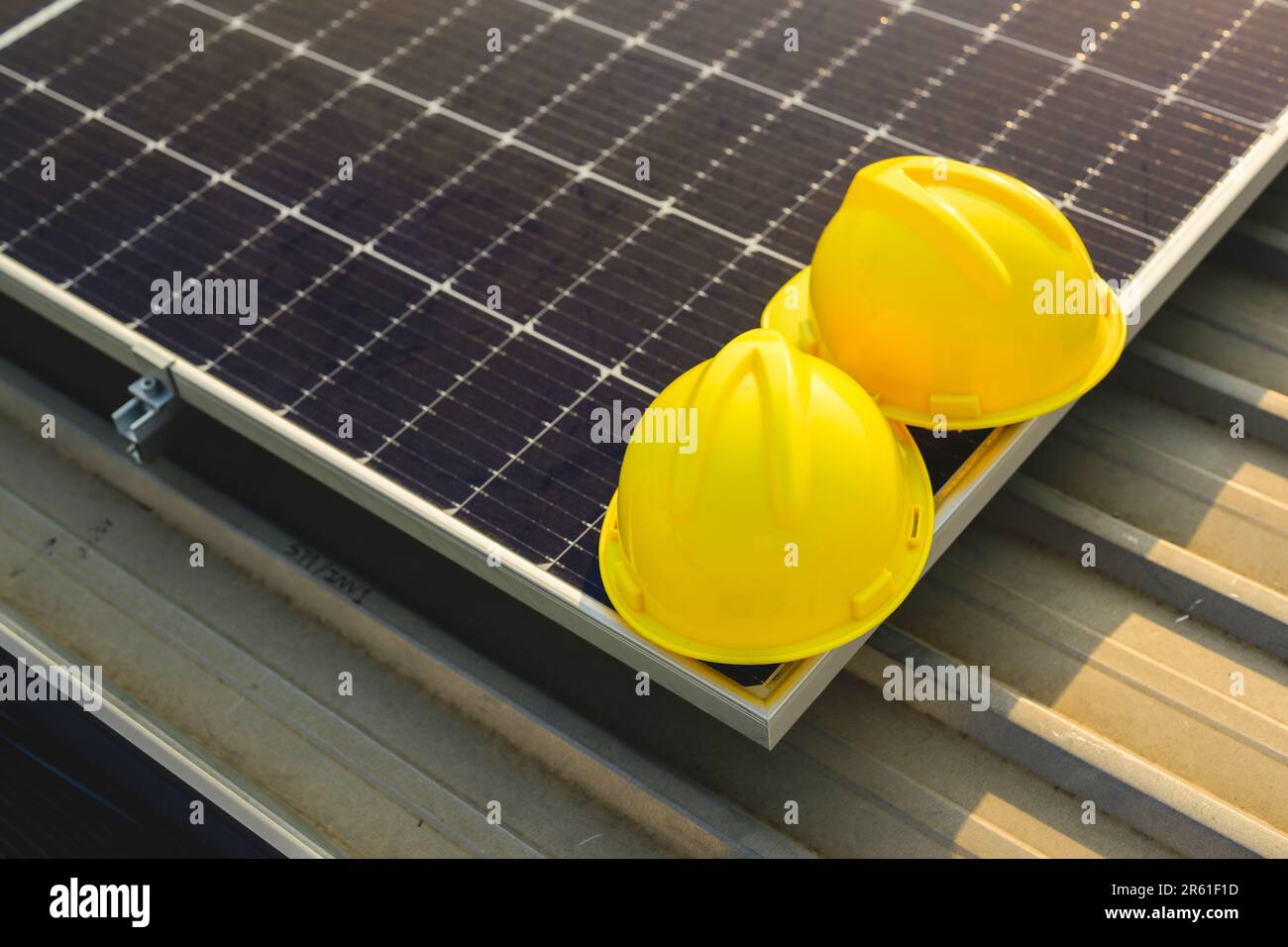 Engineer helmet on blue photovoltaic solar panels at solar cell farm ...