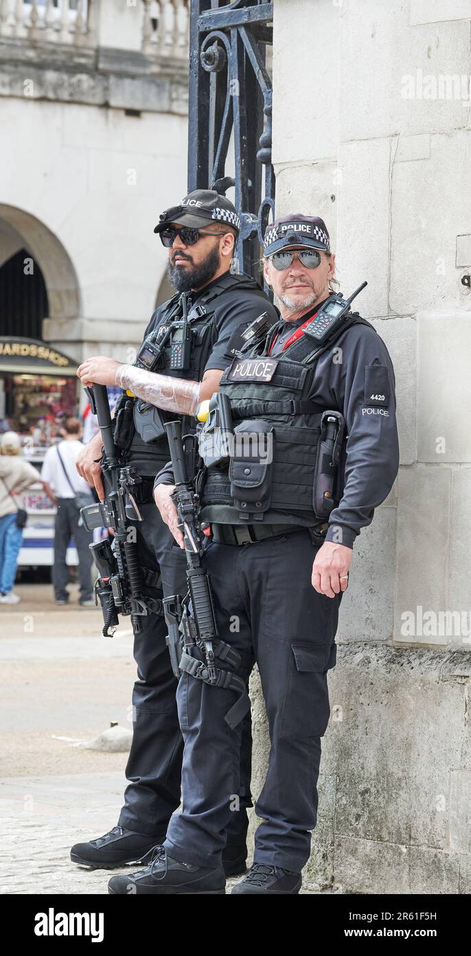 Two Metropolitan police officers, with their guns and weapons, on duty ...