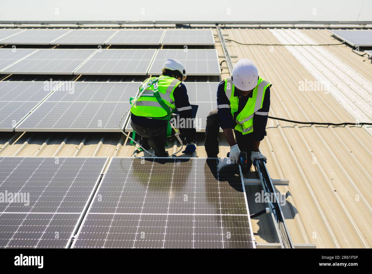 Engineers with safety helmet checking solar system at solar power farm ...
