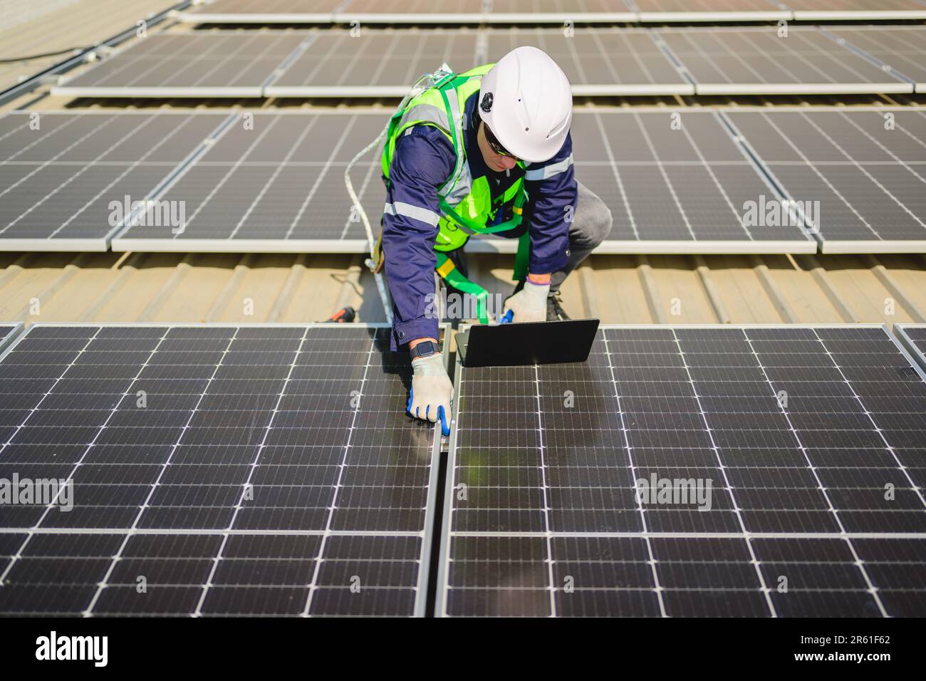 Engineers with safety helmet checking solar system at solar power farm ...