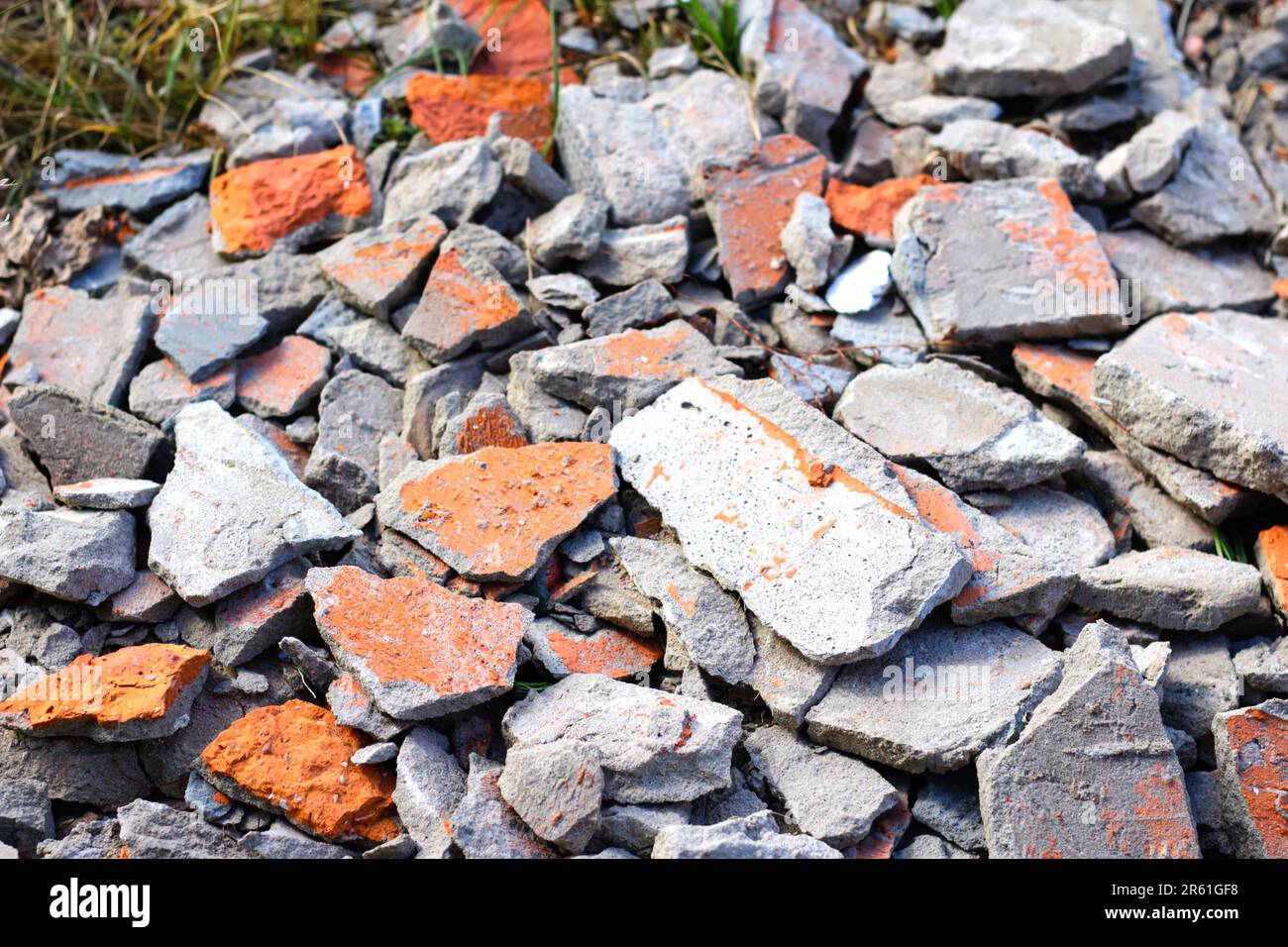 Shattered, broken bricks on nature background. rubble ruin brick building wall broken demolition ...