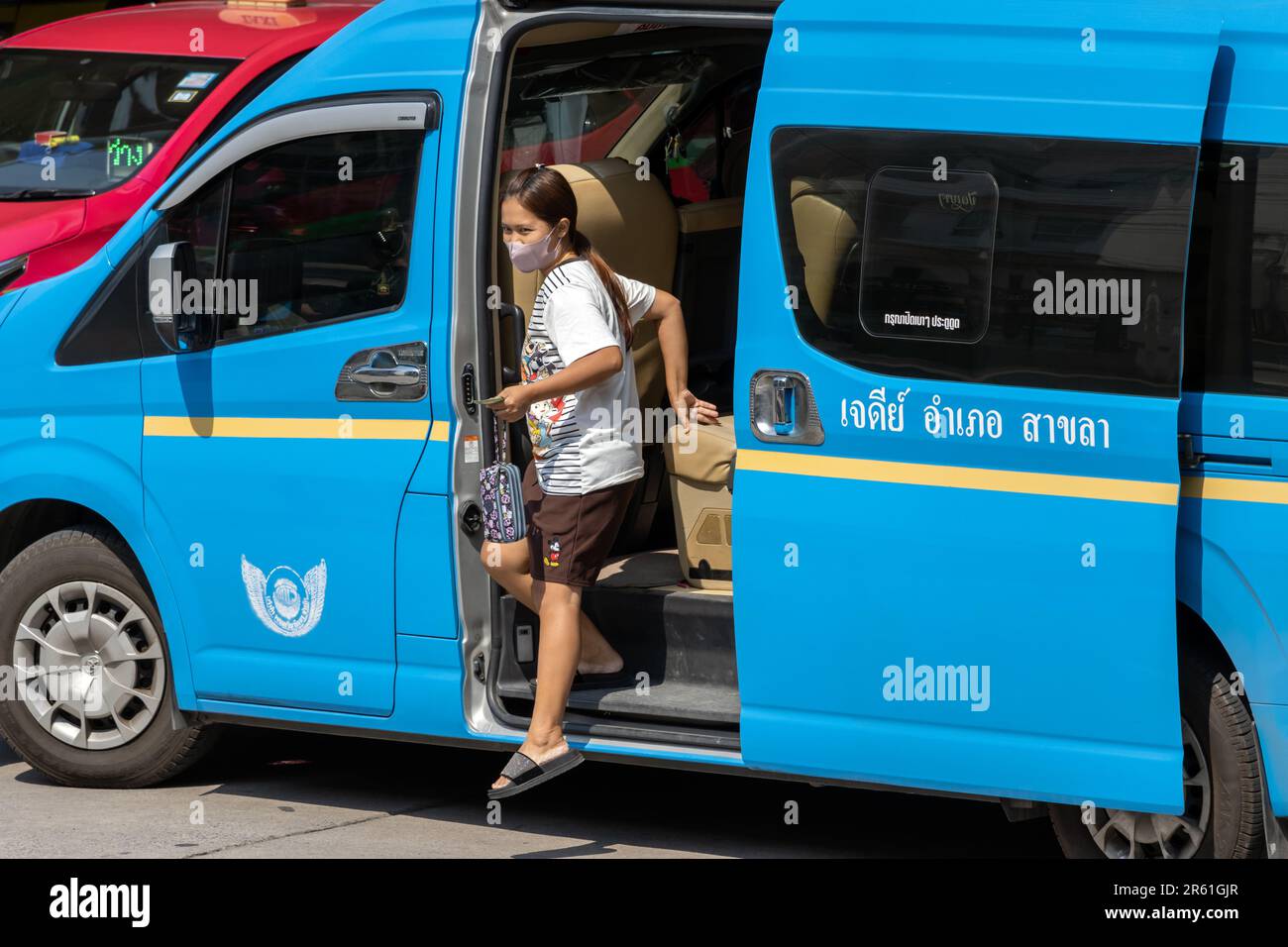SAMUT PRAKAN, THAILAND, FEB 07 2023, A woman get out of the minivan ...