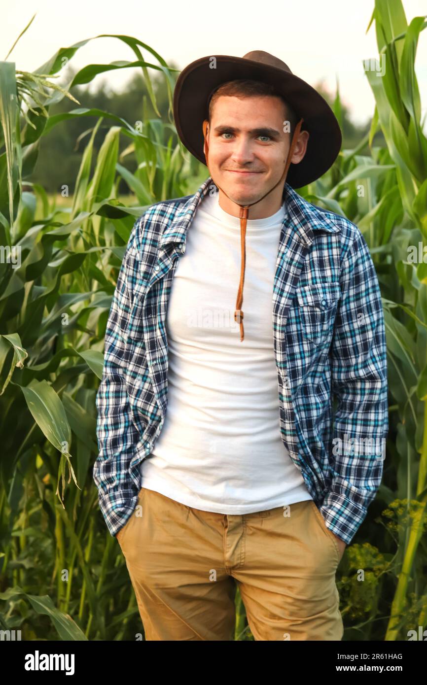Funny farmer posing in the corn field. Caucasian calm male maize grower ...