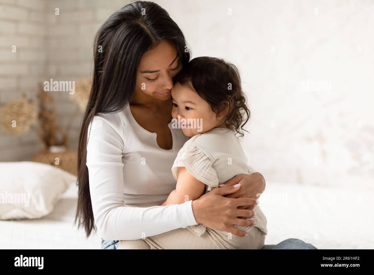 Japanese Mother Hugging Her Little Child Daughter Bonding At Home Stock Photo - Alamy