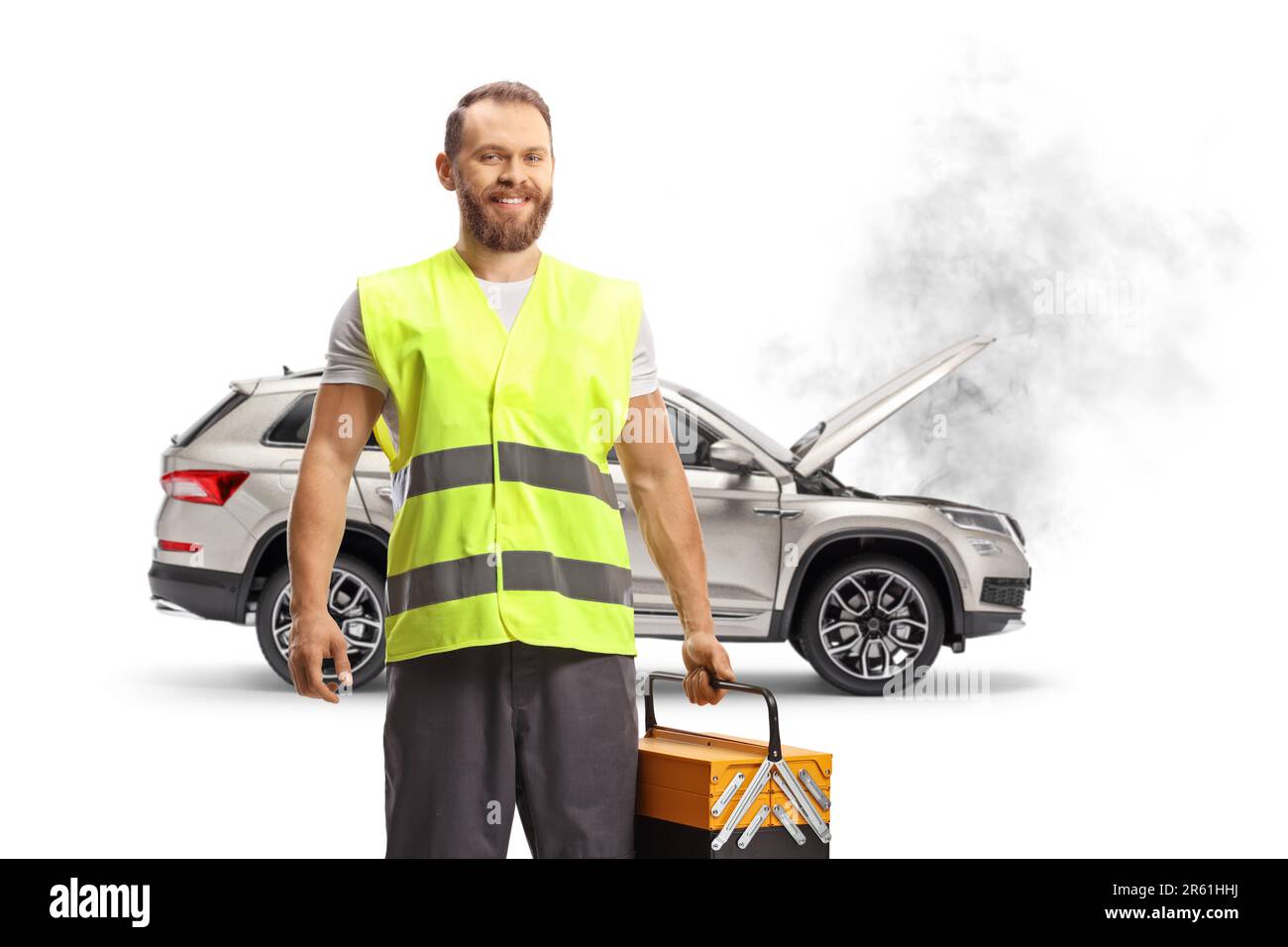 Road assistance worker in a reflective vest standing in front of a car ...