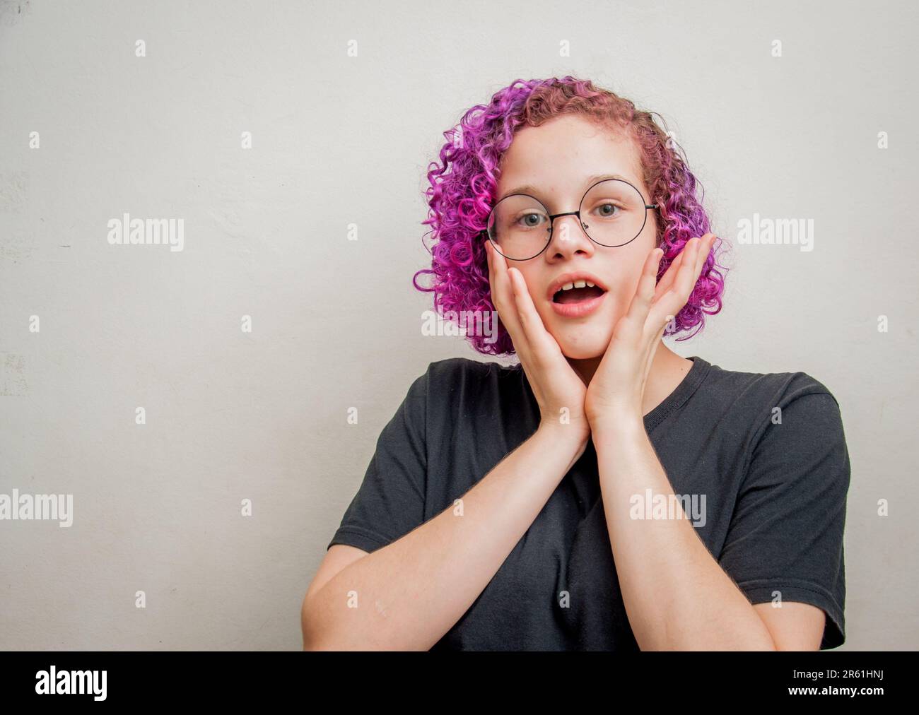 Young woman with colored hair, white background - facial expressions ...