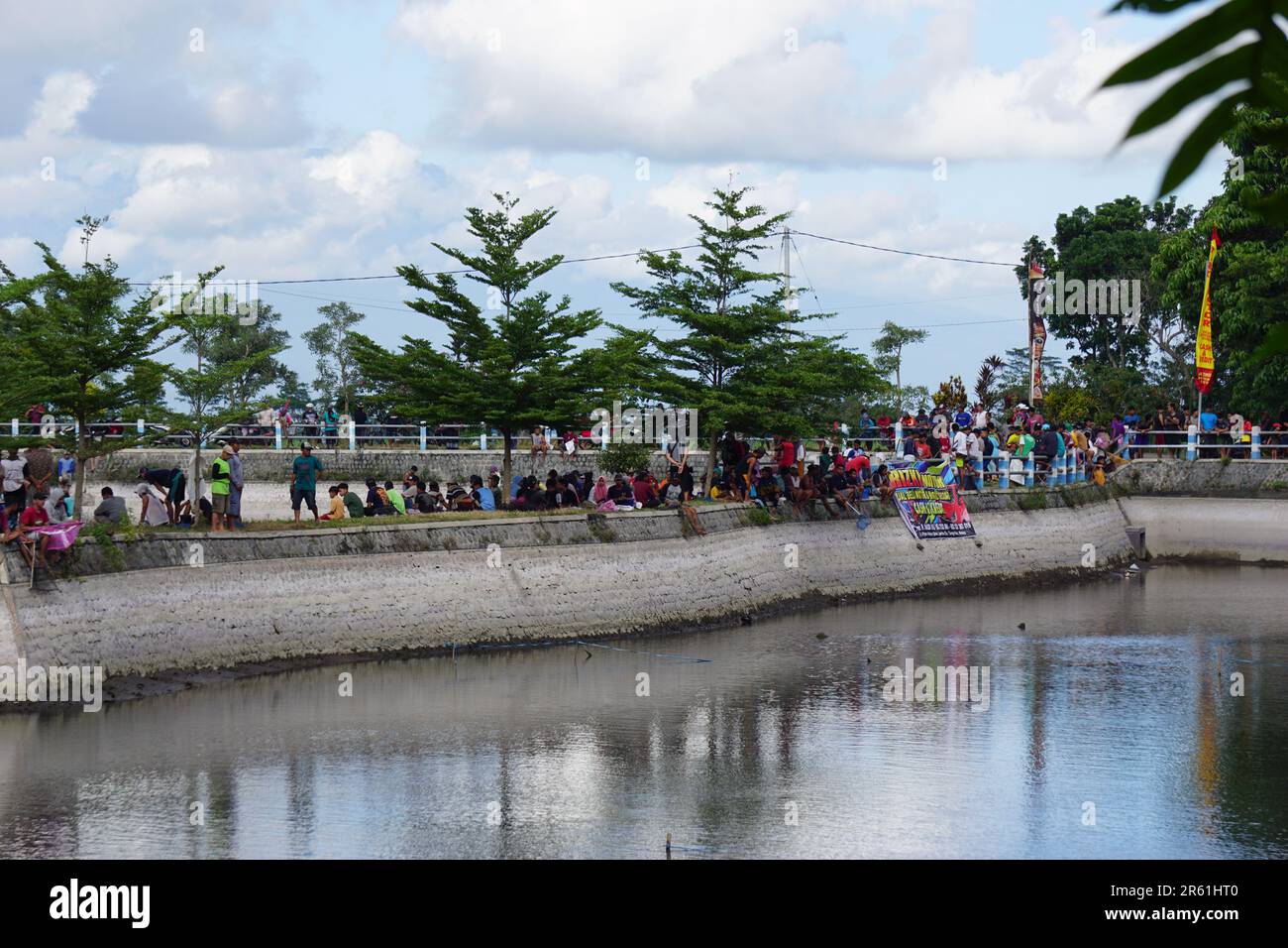People fishing on gropyok iwak at sumber jembangan. Gropyok iwak means ...