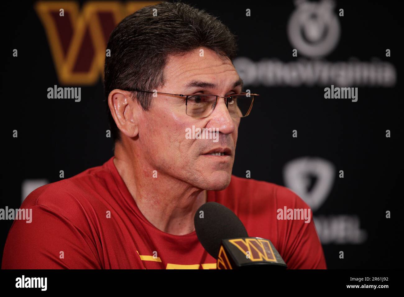 Washington Commanders head coach Ron Riviera talks to members of the ...