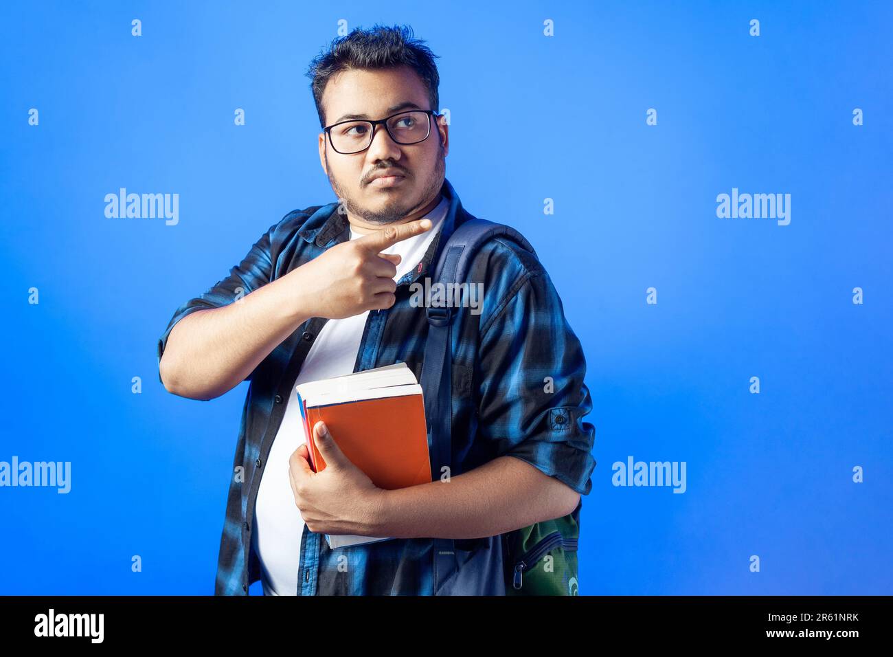 male handsome student pointing finger towards copy space Stock Photo ...