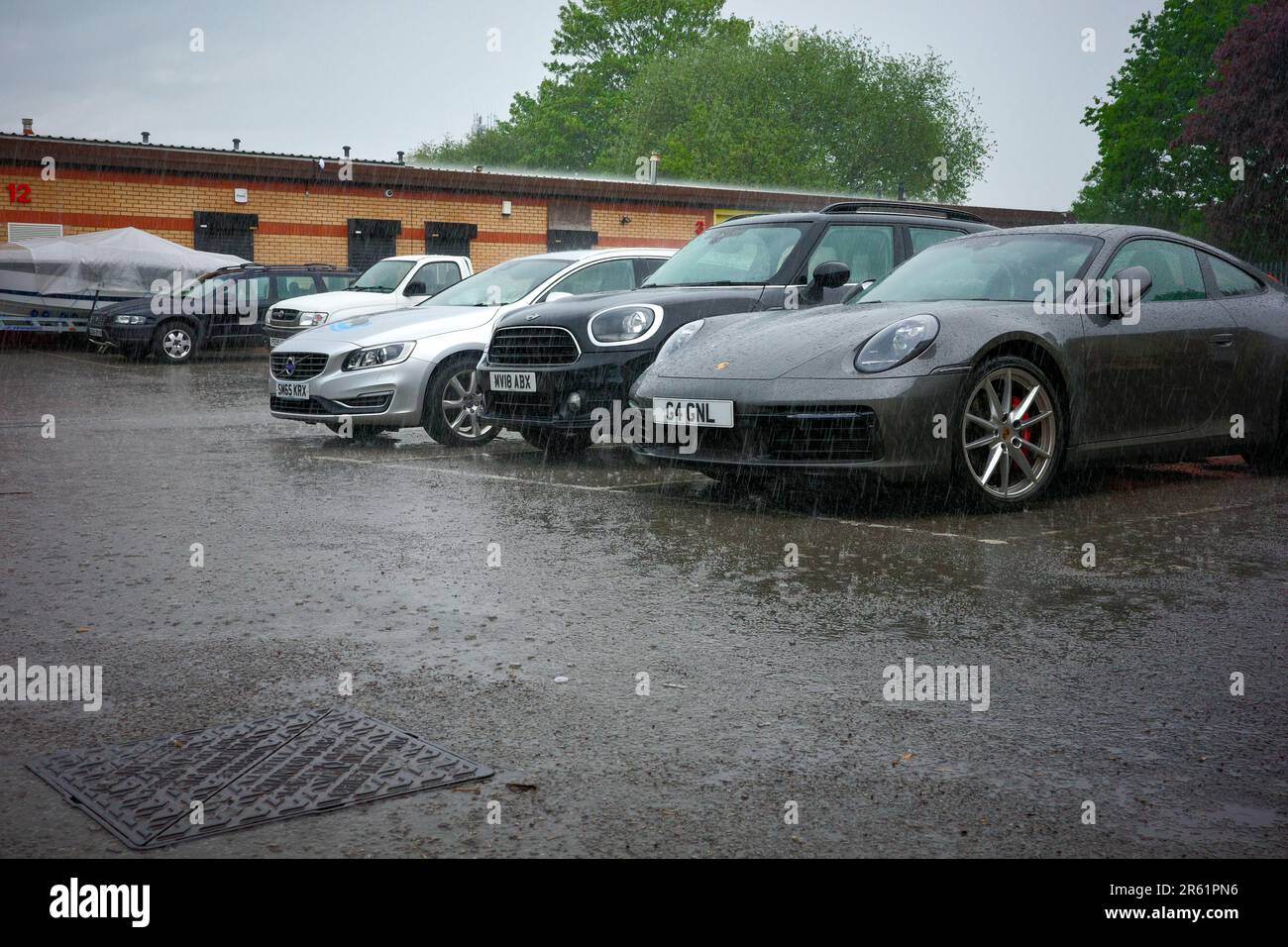 cars parked in the parking lots with lots of heavy rain pouring down ...