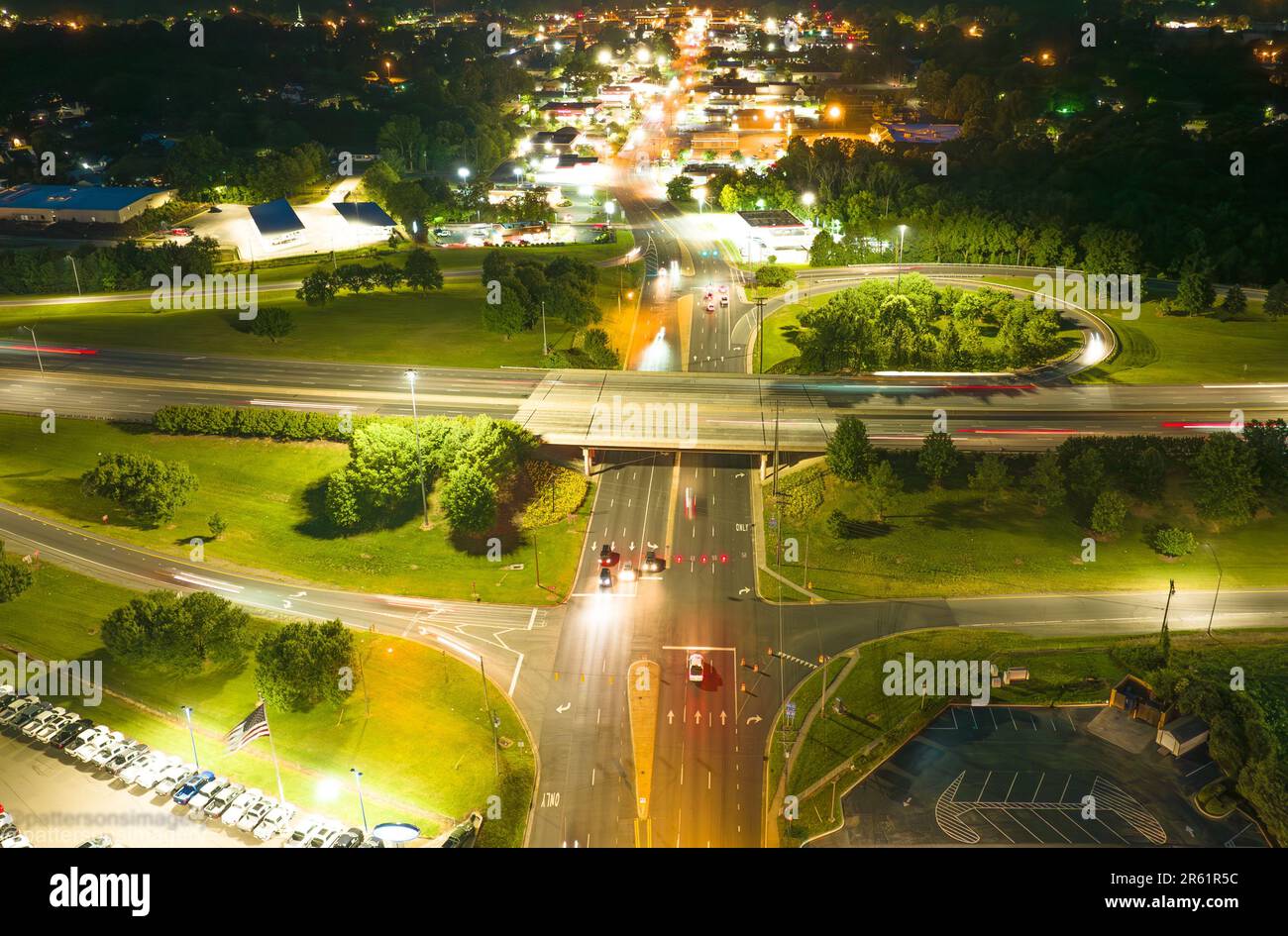 A bustling city street at night, illuminated by the glow of street ...