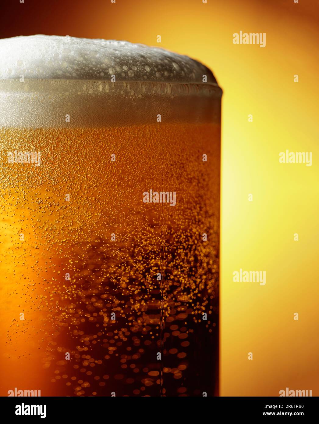 Glass of tasty beer with foam, closeup. Pouring beer with bubble froth ...