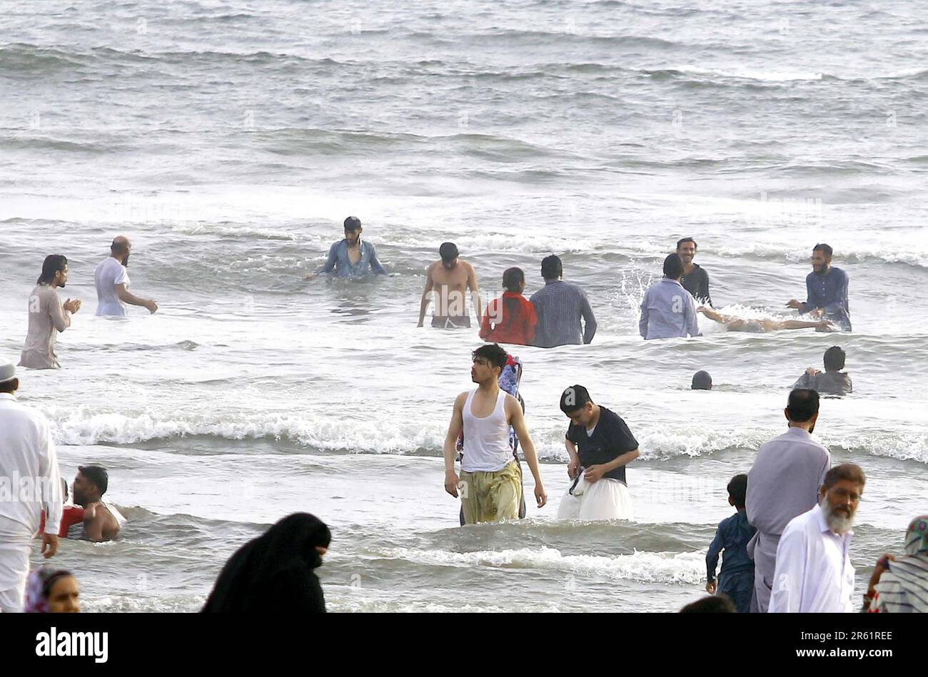 Karachi, Pakistan, June 6, 2023. A large numbers of people are enjoying and cooling themselves ...
