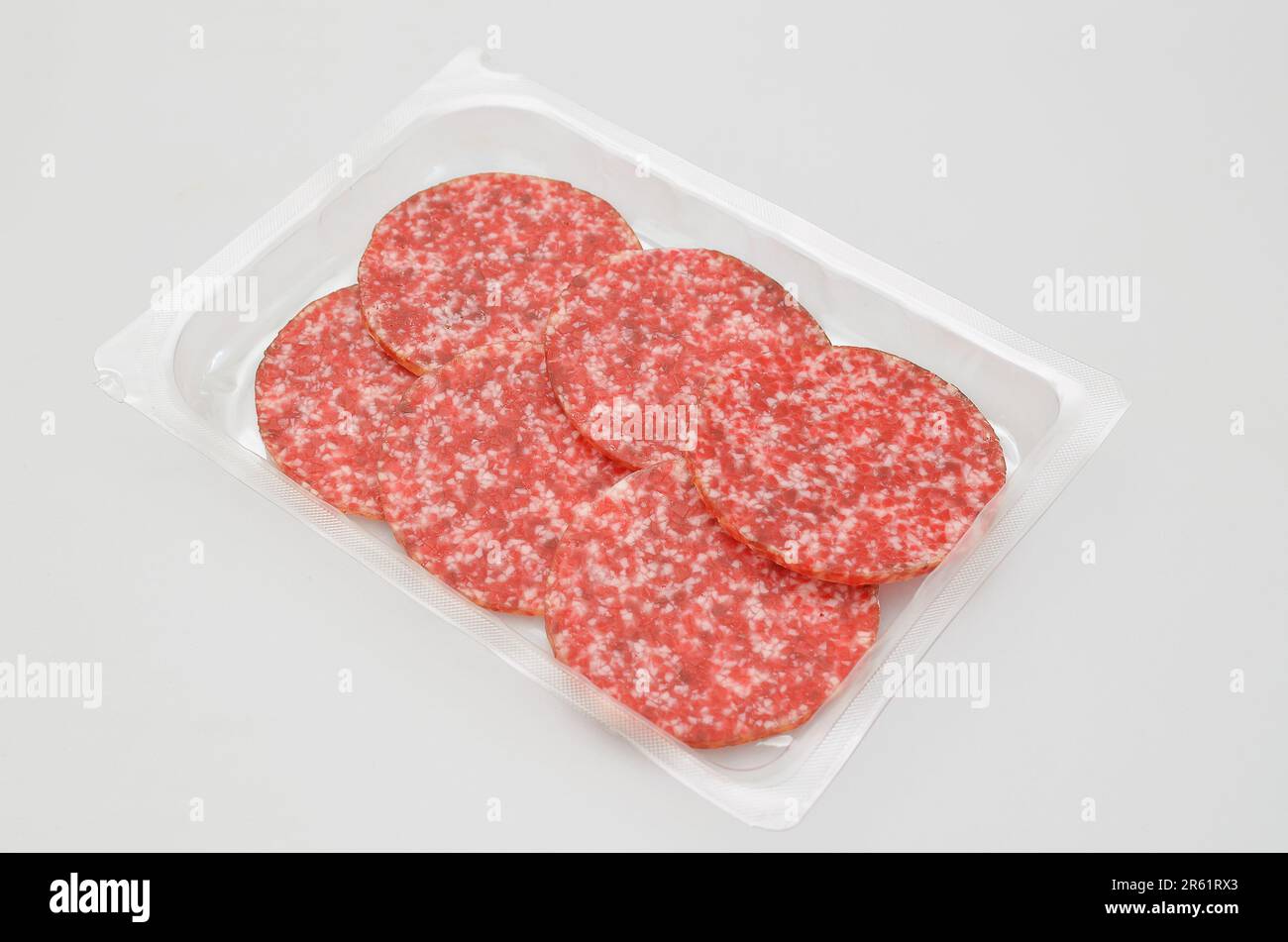 Slices of Salami in a plastic box, isolated on white background Stock ...