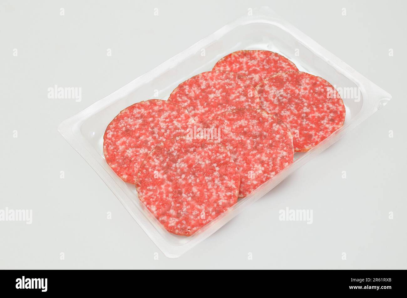 Slices of Salami in a plastic box, isolated on white background Stock ...