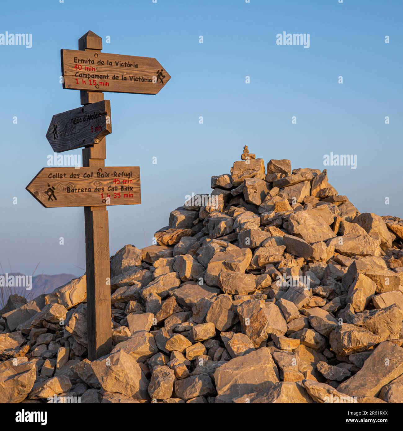 A trio of directional signs atop a stack of hefty stones Stock Photo ...