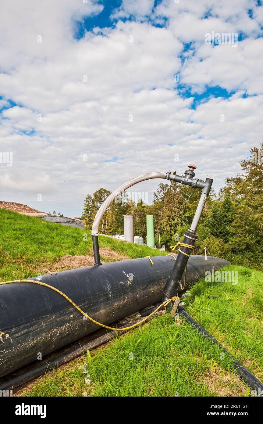 A vertical landfill methane gas wellhead and valve at an active ...