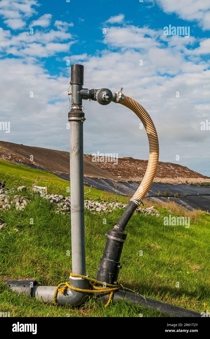 A vertical landfill methane gas wellhead and valve at an active ... A vertical landfill methane gas wellhead and valve at an active ...
