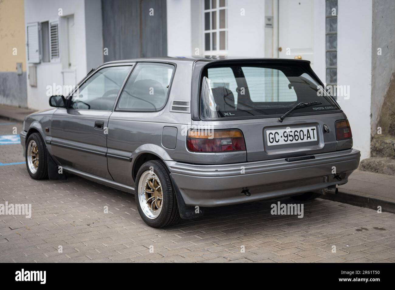 A gray classic Japanese car, the small Toyota Corolla XL EE90 parked on ...